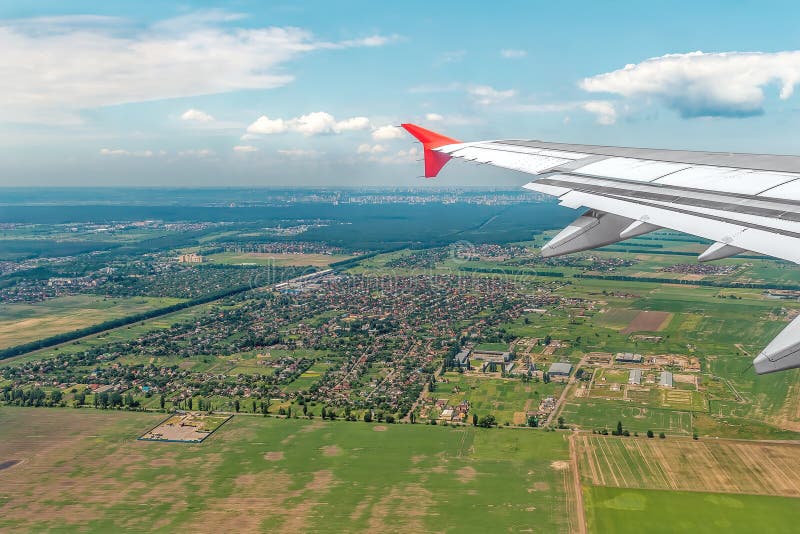 Wing of an Airplane Flying Low Over a Ukrainian Town in Summer Stock ...