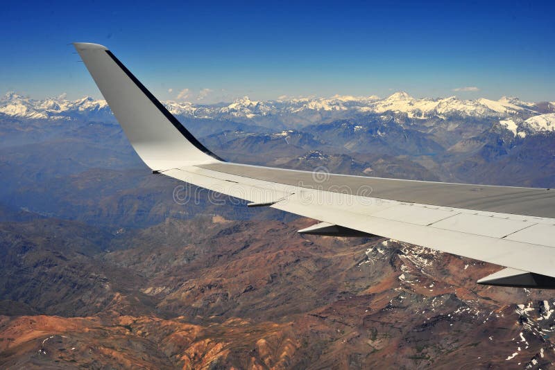 Airplane Flying Over the Morning Clouds Crossing the Andes Mountain ...