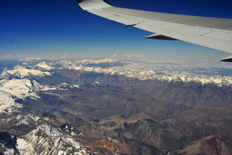 Airplane Flying Over the Morning Clouds Crossing the Andes Mountain ...