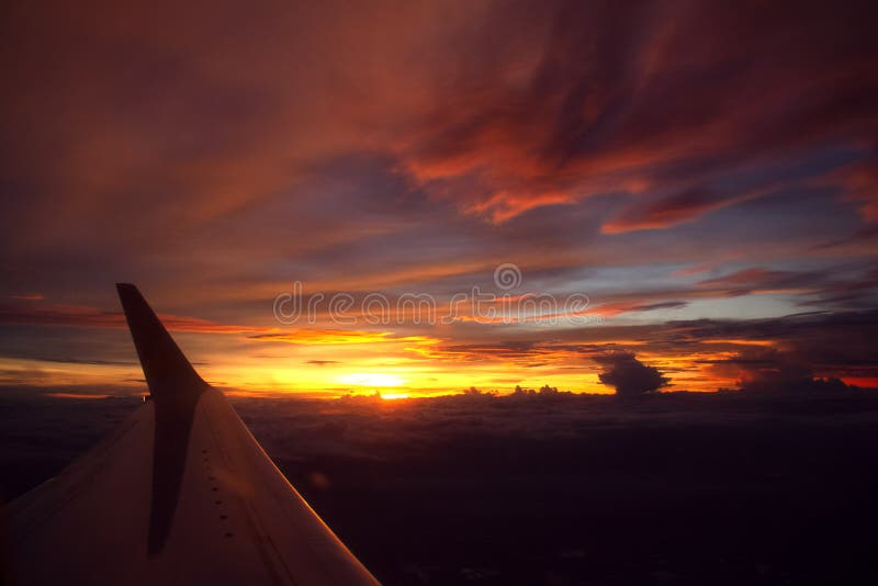 Wing of Airplane Over the Cloud and the Sunset Stock Image - Image of ...