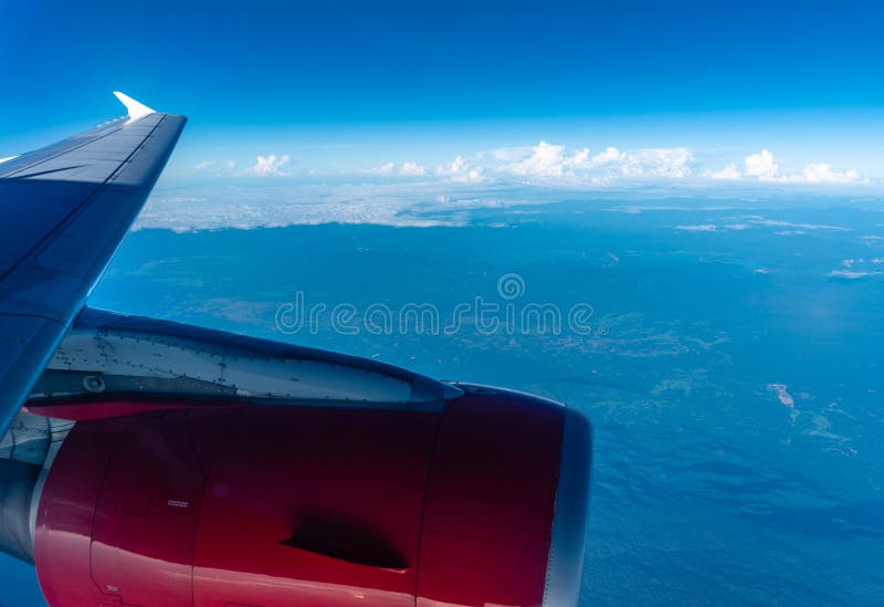 Wing and Engine of Airplane Flying with Cloud and Landscape Editorial ...