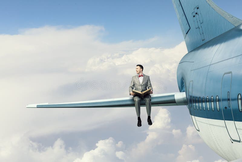 Business Travel Concept - Businessman Sitting On A Plane Wing Stock ...
