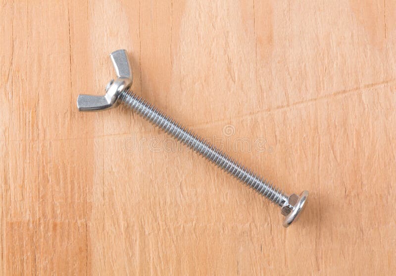 Wing Nut and Threaded Bolt on Plywood Stock Photo - Image of wing, used ...
