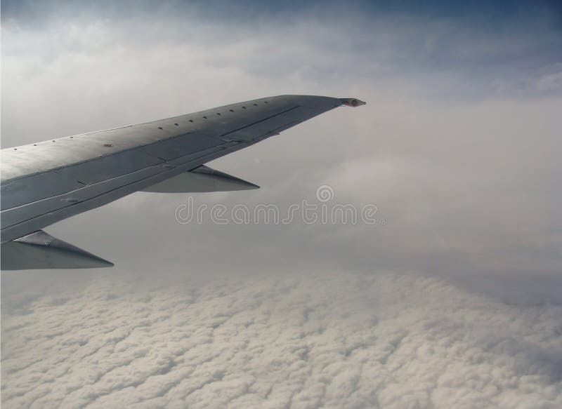 Wing over clouds stock photo. Image of white, wing, flying - 84371748