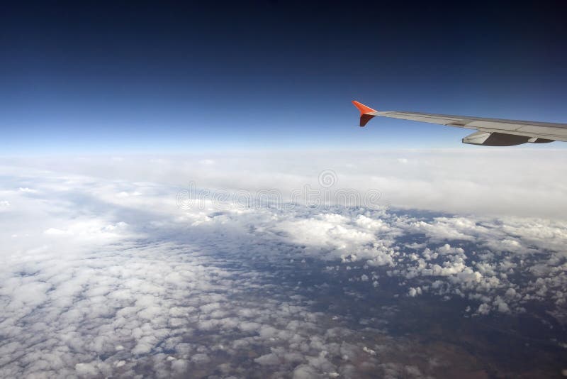 The Wing of the Plane Above the Clouds in the Sky. Stock Photo - Image ...