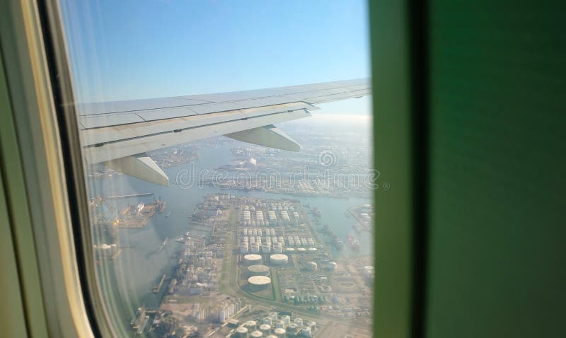 Wing of a Plane As Seen through an Airplane Window with the Earth ...