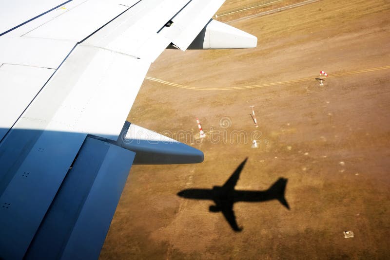 Wing and Shadow of a Plane during the Flight. Stock Image - Image of ...