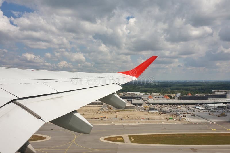 The Wing of a Take-off Airplane. Below is the Airport. Stock Photo ...