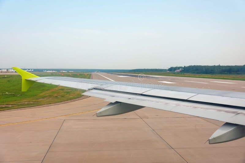 Wing View Runway at the Airport Sky and a Airplane Taking Off in the ...
