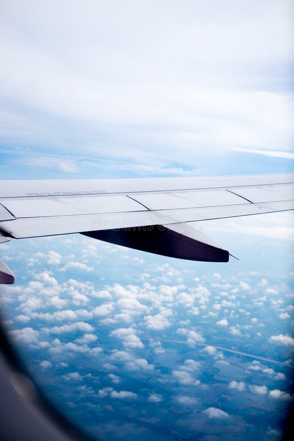 Wing of Windows Airplane Flying Above the Clouds Stock Photo - Image of ...