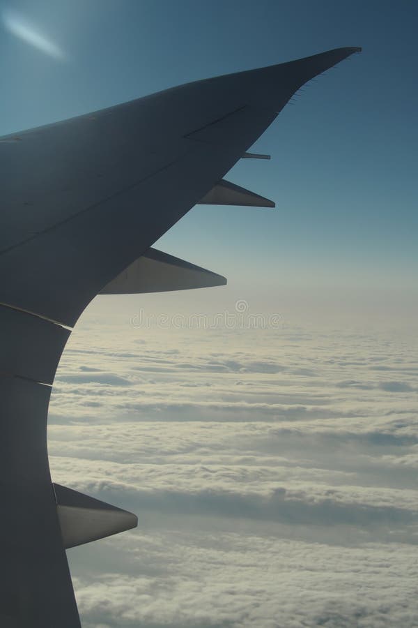 The Wings of the Plane on a Cloud Background and the Bright Sky. To ...