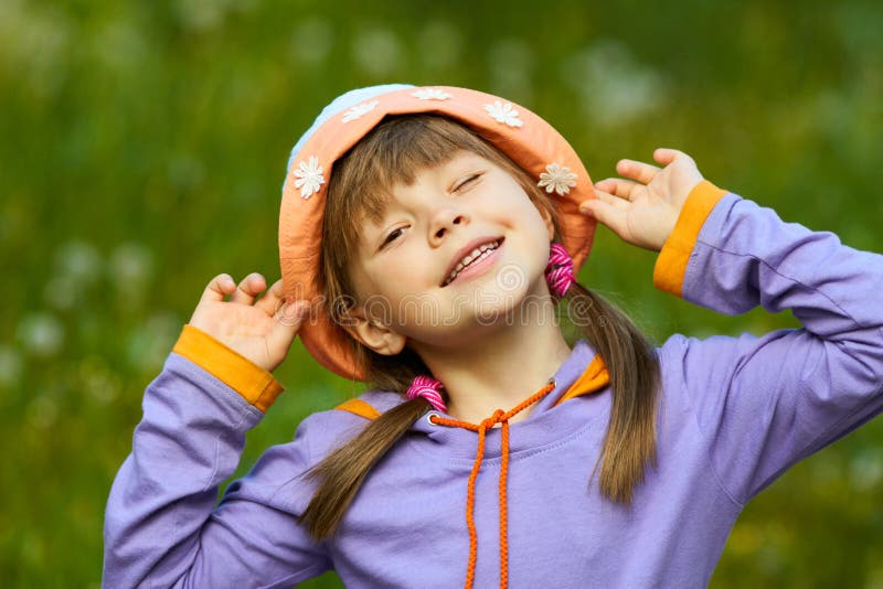 Pretty Winks Young Girl on the Green Bright Background Stock Photo ...