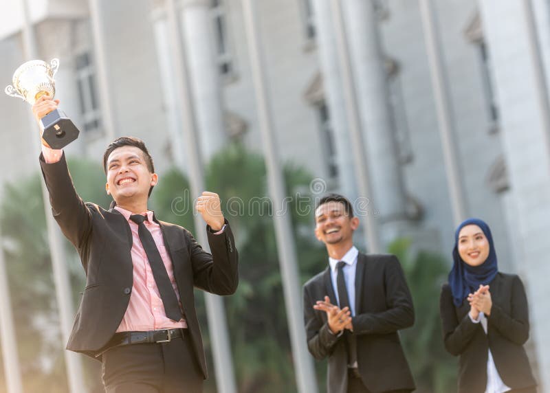 Winner! Man Wins an Award with Team Members Support Behind Stock Image ...