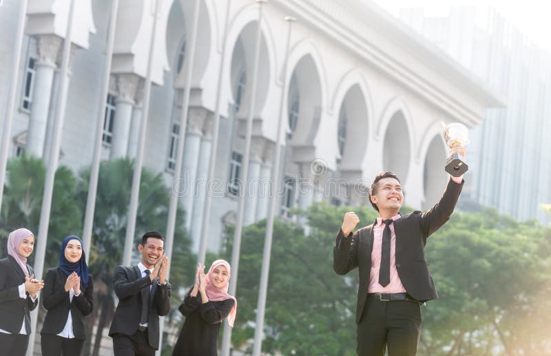 Winner! Man Wins an Award with Team Members Support Behind Stock Photo ...