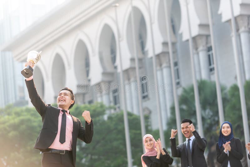 Winner! Man Wins an Award with Team Members Support Behind Stock Photo ...