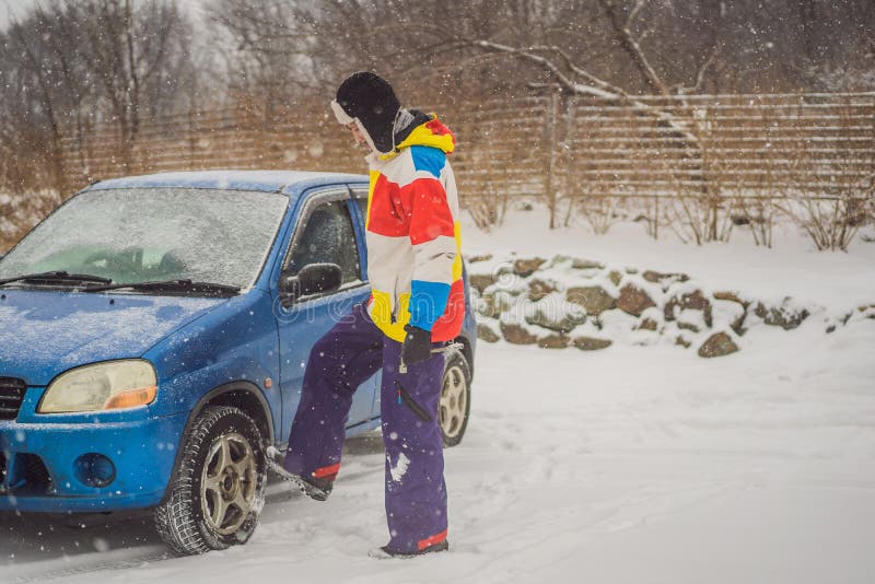 Winter Accident on the Road. a Man Changes a Wheel during a Snowfall ...