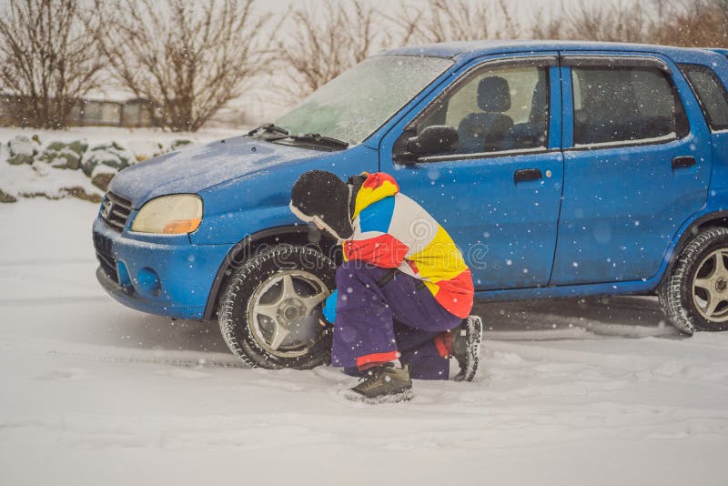 Winter Accident on the Road. a Man Changes a Wheel during a Snowfall ...