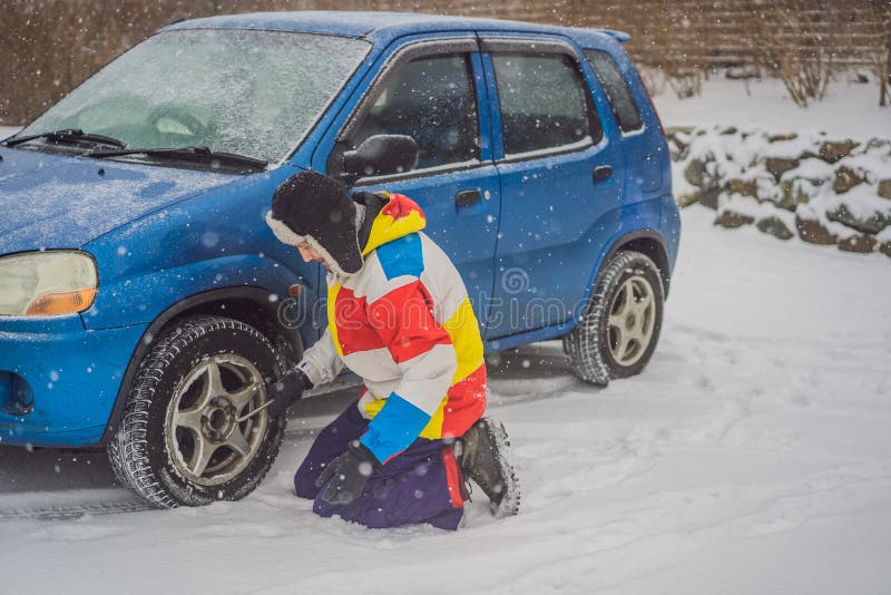 Winter Accident on the Road. a Man Changes a Wheel during a Snowfall ...