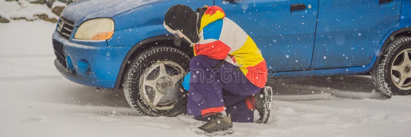 Winter Accident on the Road. a Man Changes a Wheel during a Snowfall ...