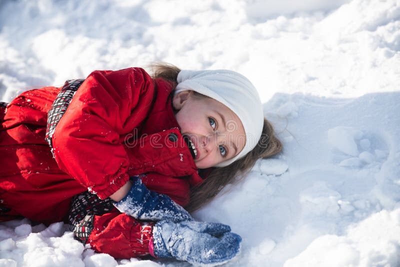 Winter Child Girl Laying in the Snow. Stock Photo - Image of laying ...