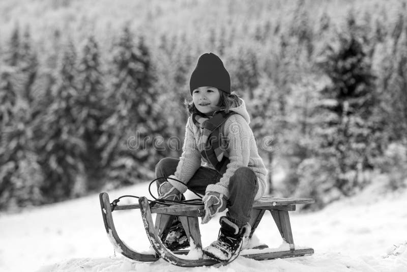 Winter Child Sliding on a Sled in Snowy Park. Stock Photo - Image of ...