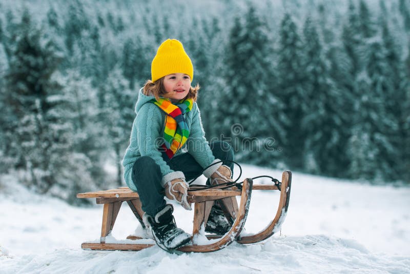 Winter Child Sliding on a Sled in Snowy Park. Stock Photo - Image of ...