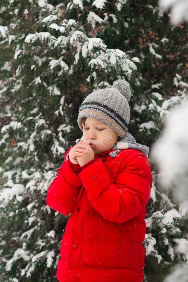 Winter Cold. the Boy Blows on His Hands, Warming Them Stock Photo ...