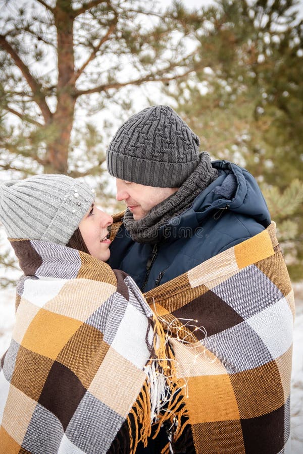 In Winter, a Couple in Love in the Park Cuddle and Wrap a Plaid Stock ...