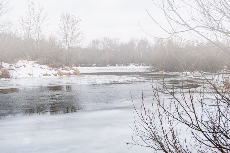 The Winter Fog Over the River. Thawing in the Ice of River Stock Photo ...
