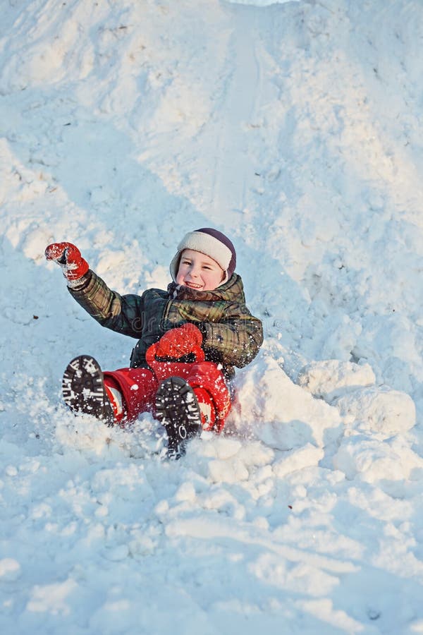 Child Slides Down a Snowy Hill Stock Image - Image of sledding, human ...