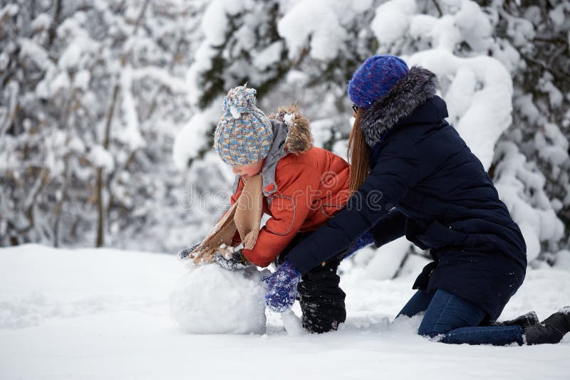 Winter Fun. a Girl and a Boy Making Snowballs. Stock Image - Image of ...