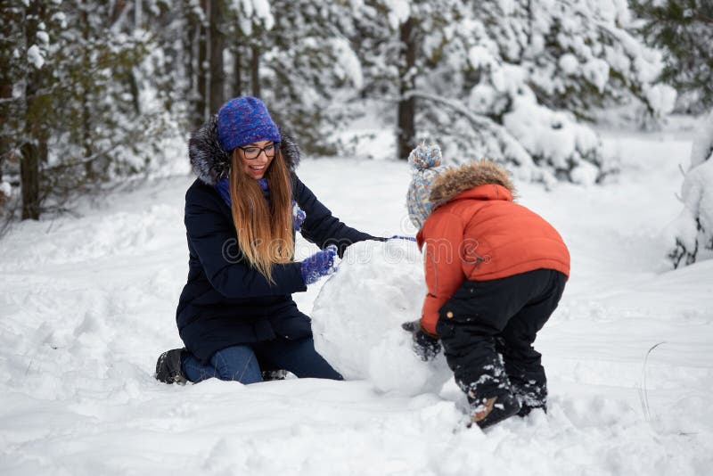 Winter Fun. a Girl and a Boy Making Snowballs. Stock Image - Image of ...