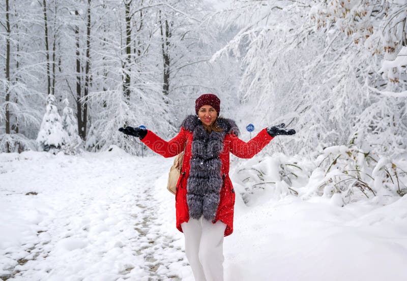 Winter, a Girl on a Walk in the Forest Cheerfully Throws Up Snow. Stock ...