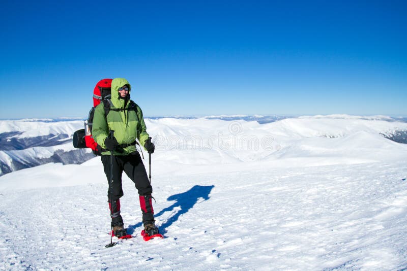 Winter Hiking in the Mountains on Snowshoes with a Backpack and Tent ...