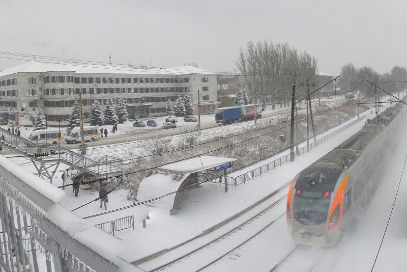 A Winter Image Showcases a Sleek Train Pulling into a Snowy Station ...