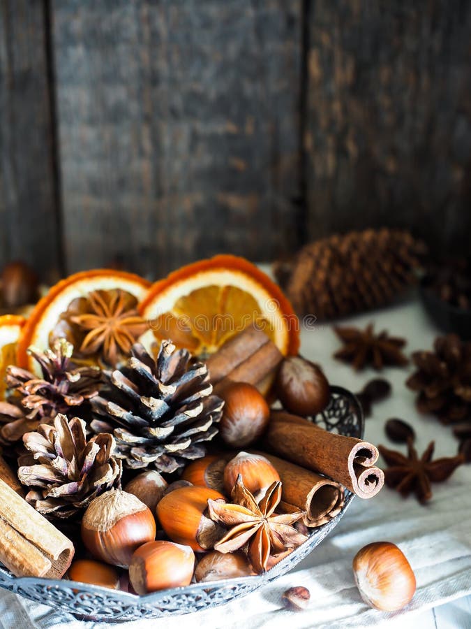 Winter Ingredients Nuts, Cones, Oranges, Cinnamon Star Anise in a Bowl ...