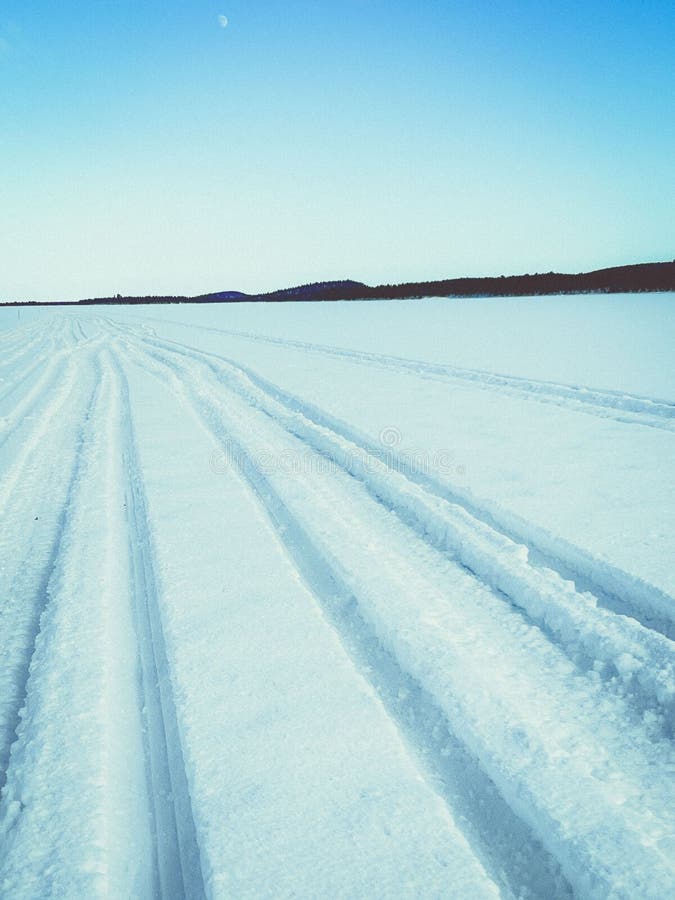 There is Some Very Long Lines in the Snow on the Ground Stock Image ...