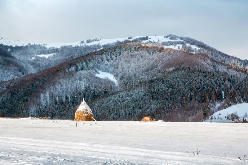 Winter Landscape, a Haystack on the Background of Snow-capped Mountains ...