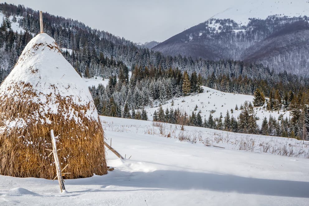 Winter Landscape, a Haystack on the Background of Snow-capped Mountains ...