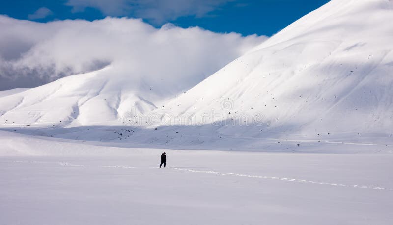 Winter Landscape, Man Walking in Snow Valley Surrounded by Hills Stock ...