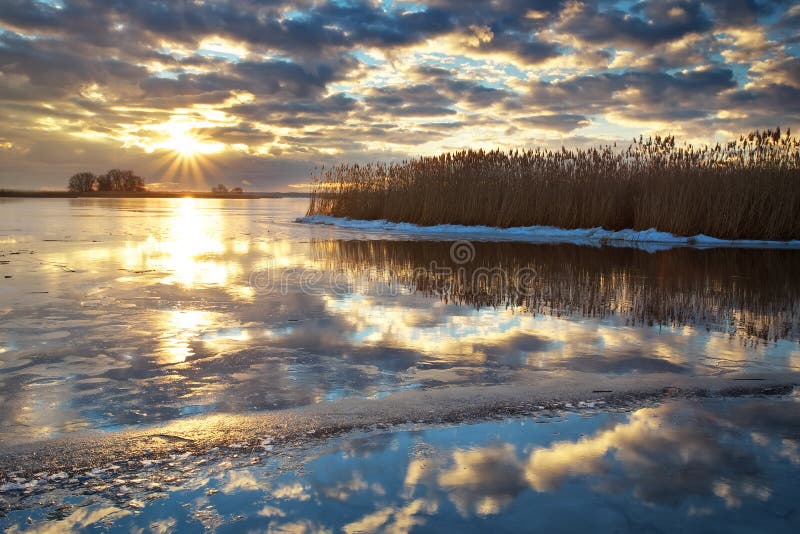 Winter Landscape with River, Reeds and Cloudy Sunset Sky. Stock Image ...