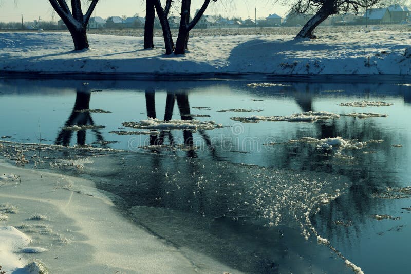 Winter Landscape. Snow-covered Shoreline with Reflection of Trees in ...