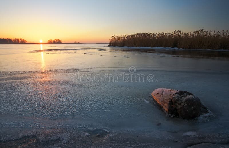 Winter Landscape with Stump in the Ice and Sunset Sky. Stock Image ...