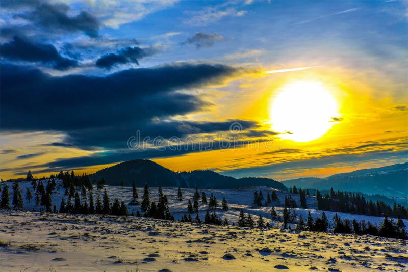 Winter Landscape with Sun Setting and Mountains Stock Image - Image of ...