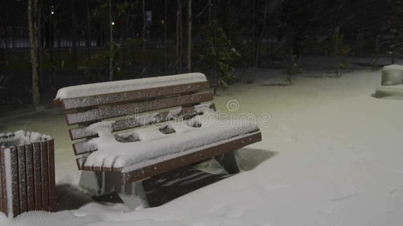 Winter Night in the Park a Bench in the Snow in the Light of a Lantern ...