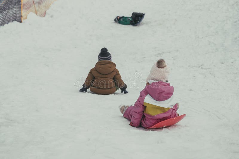 Winter Resort. Children Slide Down the Hill, Snow. Stock Image - Image ...