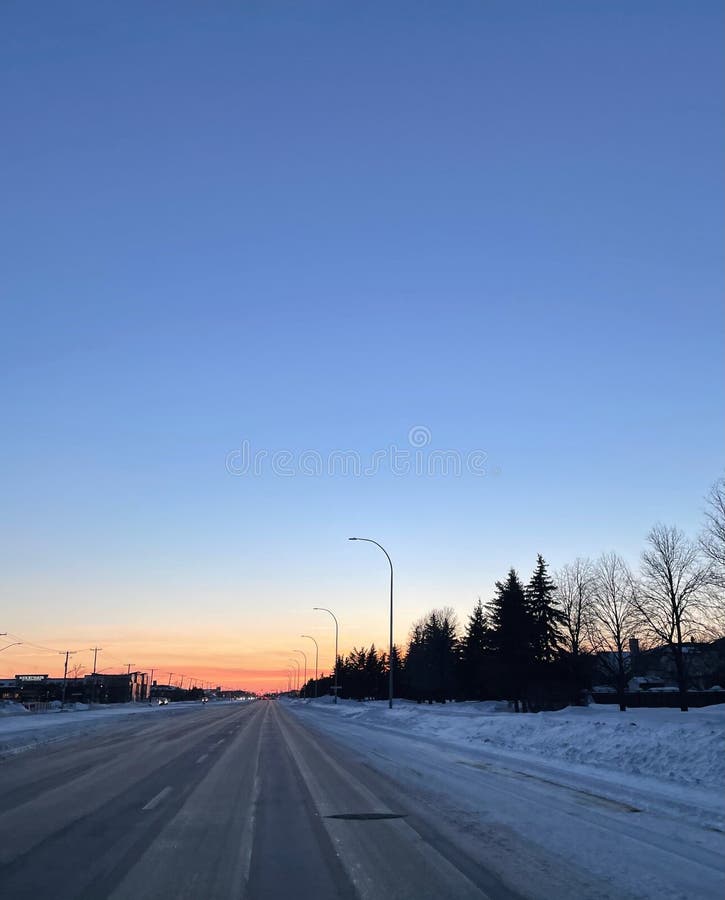 A Winter Road Horizon As the Sun is Setting Stock Photo - Image of ...