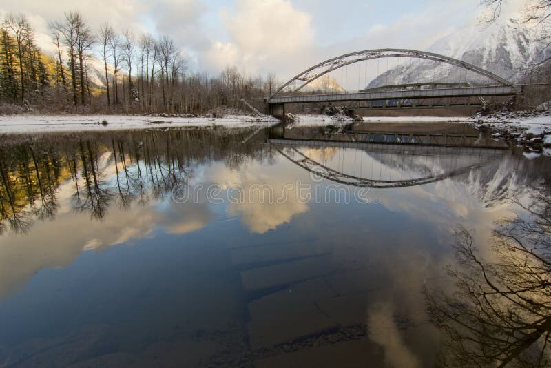 Winter Scene with Bridge and River Reflection in Northern BC. Stock ...