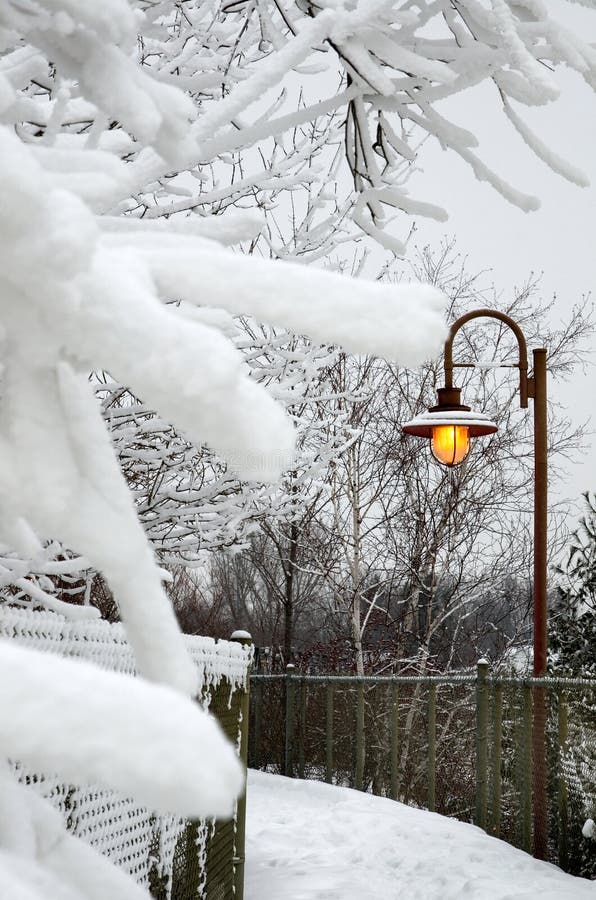 Winter Scene with Red Yellow Lampost and Snow Covered Branches Stock ...