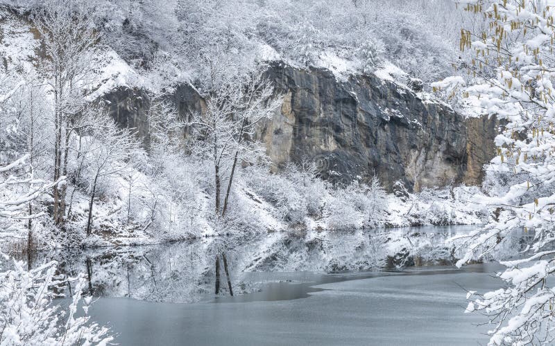 Winter Snowy Landscape with a Lake by Rock Wall Stock Image - Image of ...